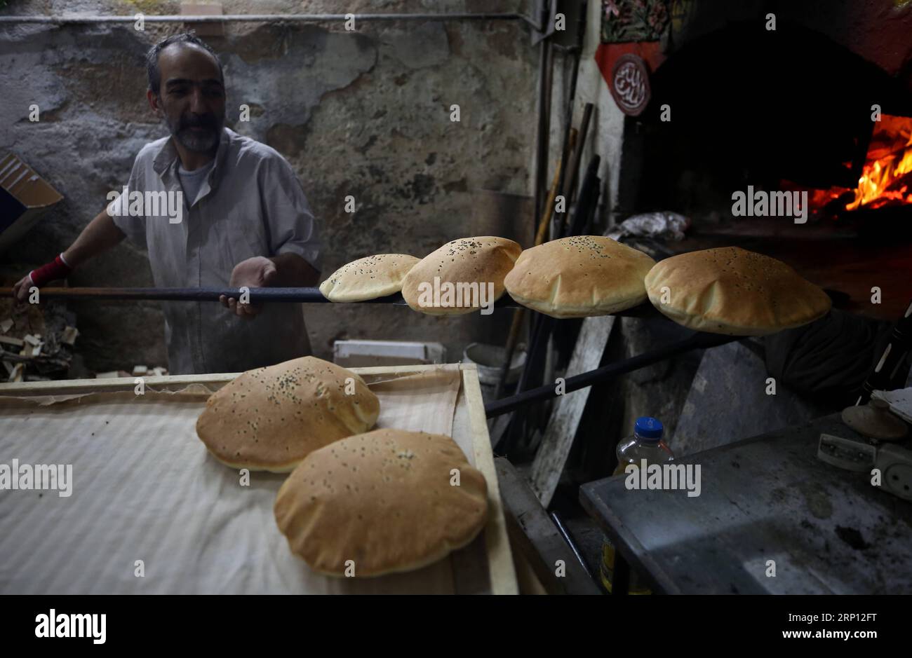 (180605) -- NABLUS, June 5, 2018 -- A Palestinian baker works at an old ...