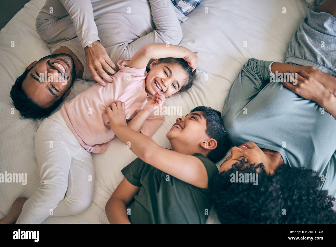 Happy family, bed and playing in bonding, weekend or day off in relax ...