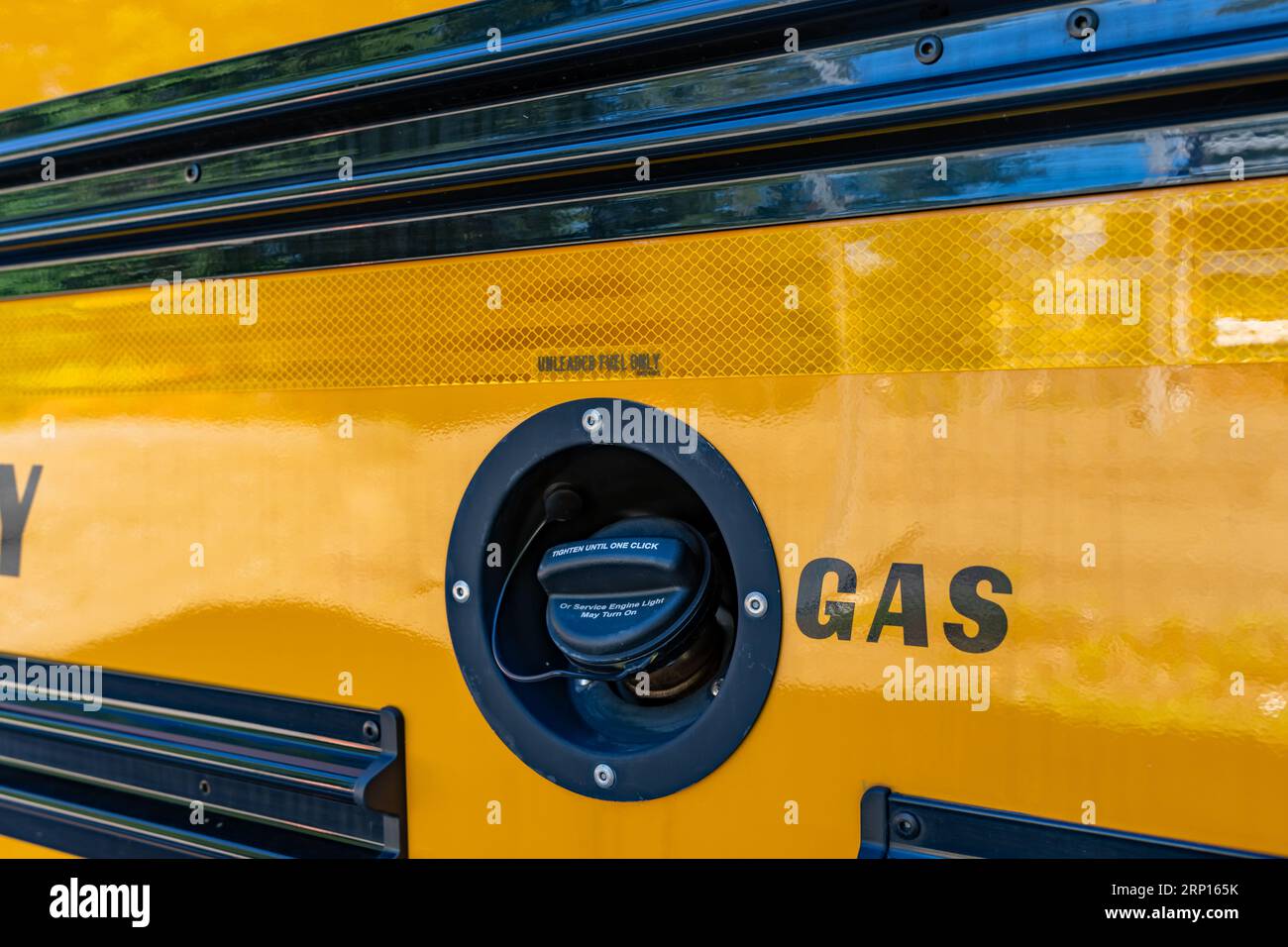 Gas cap on the side of a parked yellow school bus Stock Photo - Alamy