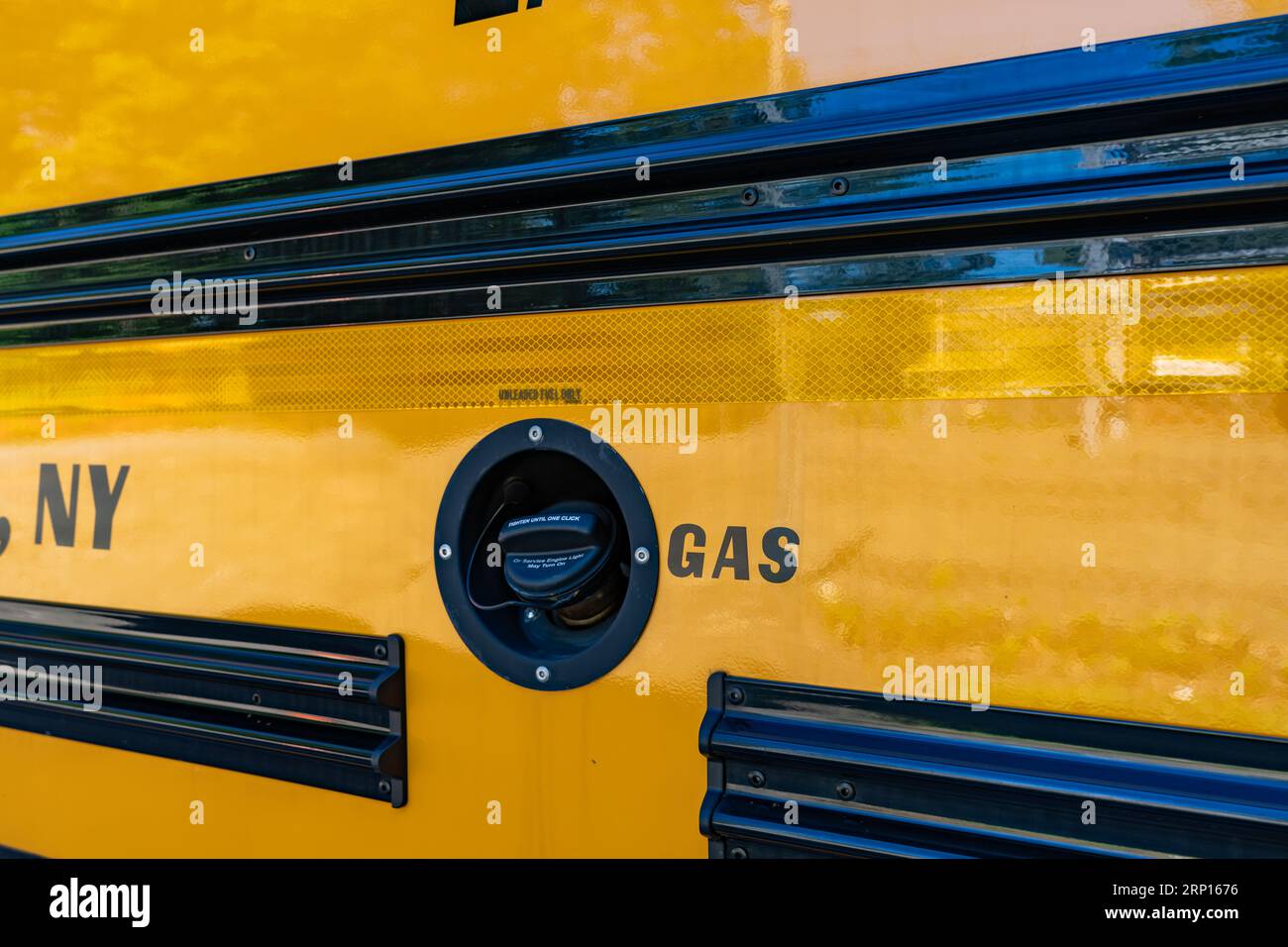 Gas cap on the side of a parked yellow school bus Stock Photo - Alamy