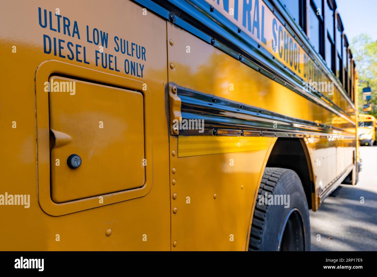 Diesel cap on the side of a parked yellow school bus Stock Photo - Alamy
