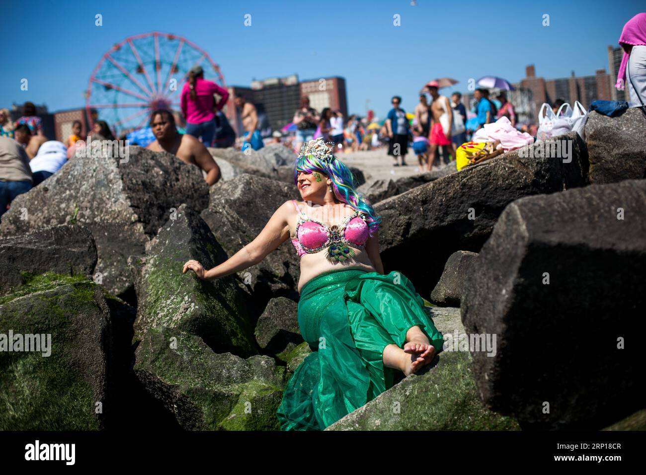 (180616) -- NEW YORK, June 16, 2018 -- A mermaid poses among the rocks ...