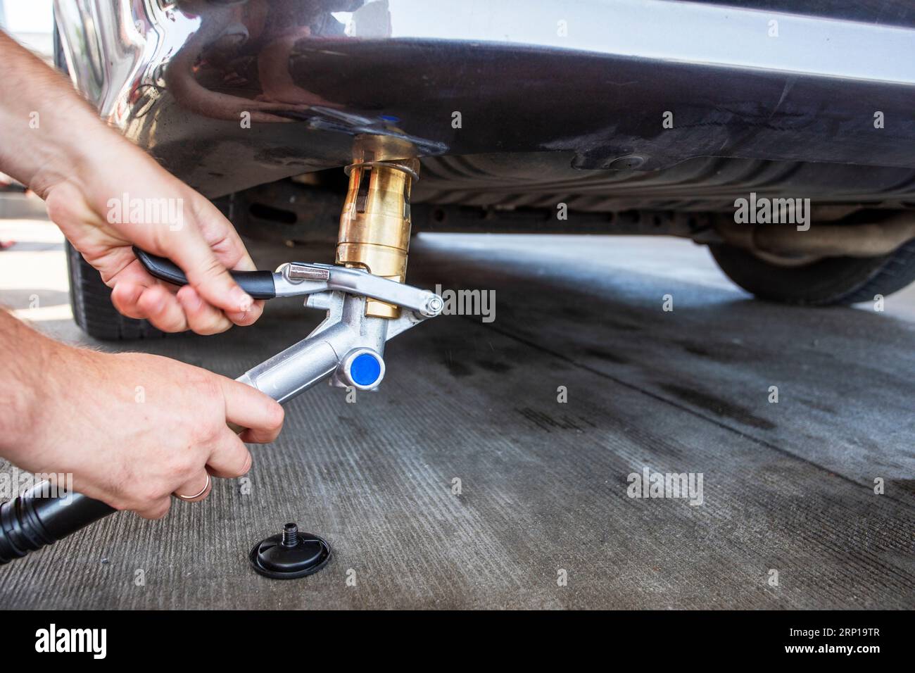 man's hand removes a gas pistol after refueling an LPG car. The Economy ...