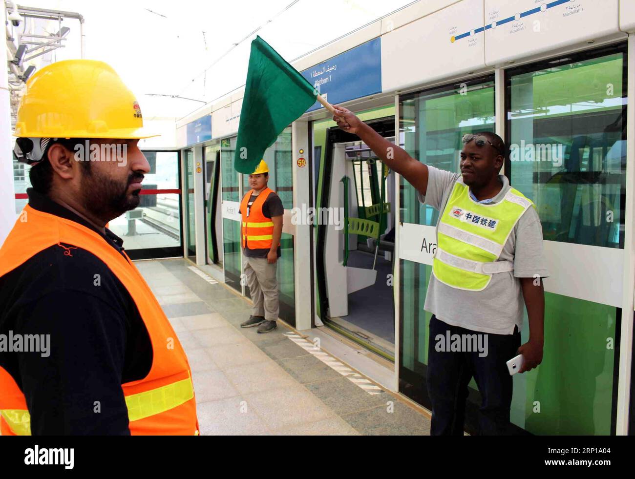 (180620) -- MECCA (SAUDI ARABIA), June 20, 2018 -- A worker signals ...