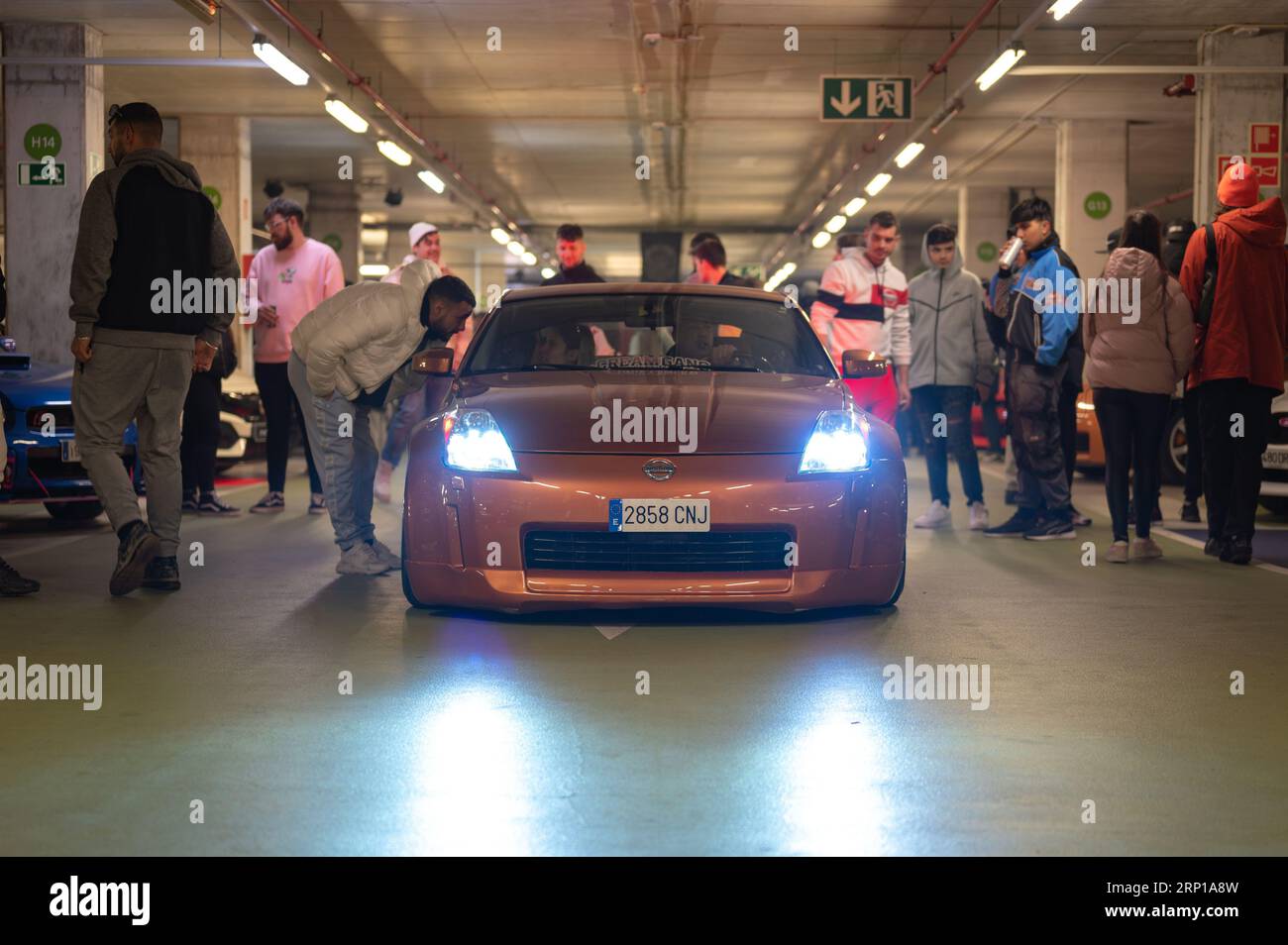 An iconic Nissan 350Z in orange color, in a concentration of Japanese ...