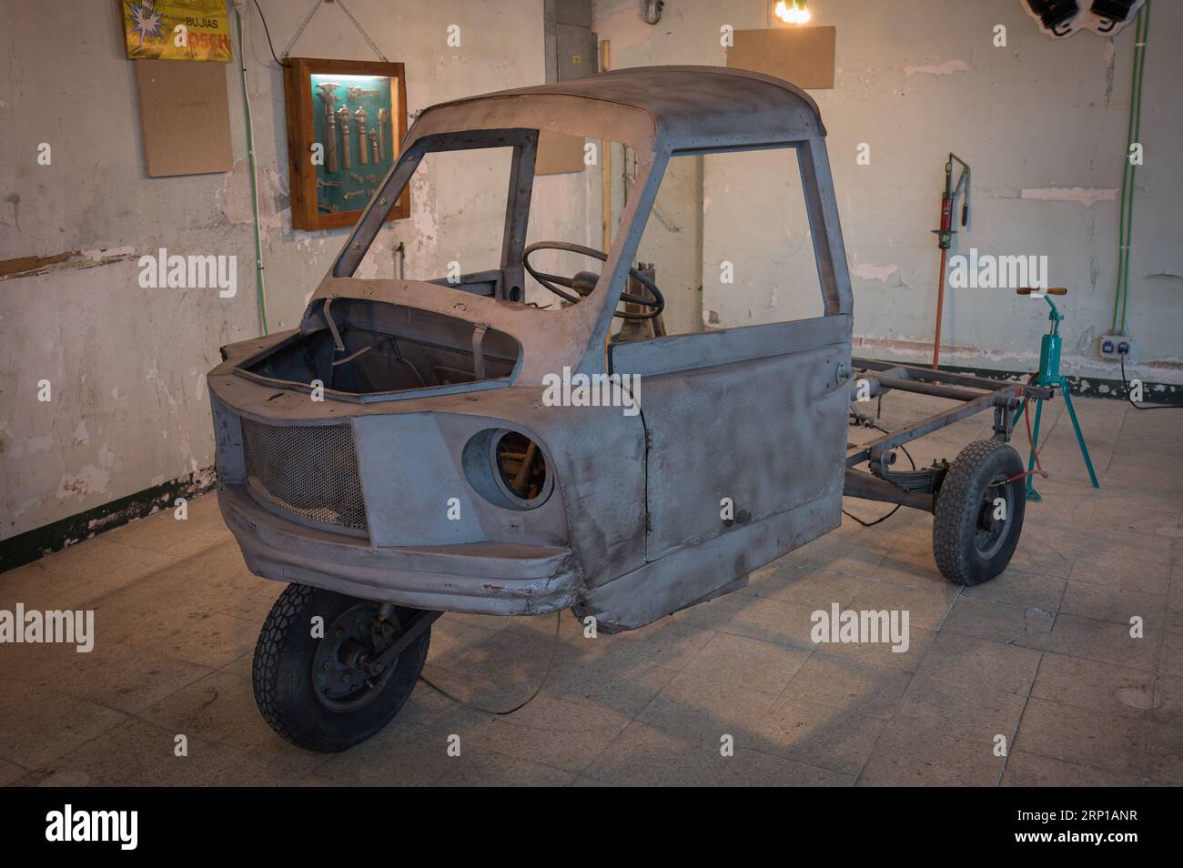 A restoration of an old microcar in an old workshop Stock Photo - Alamy