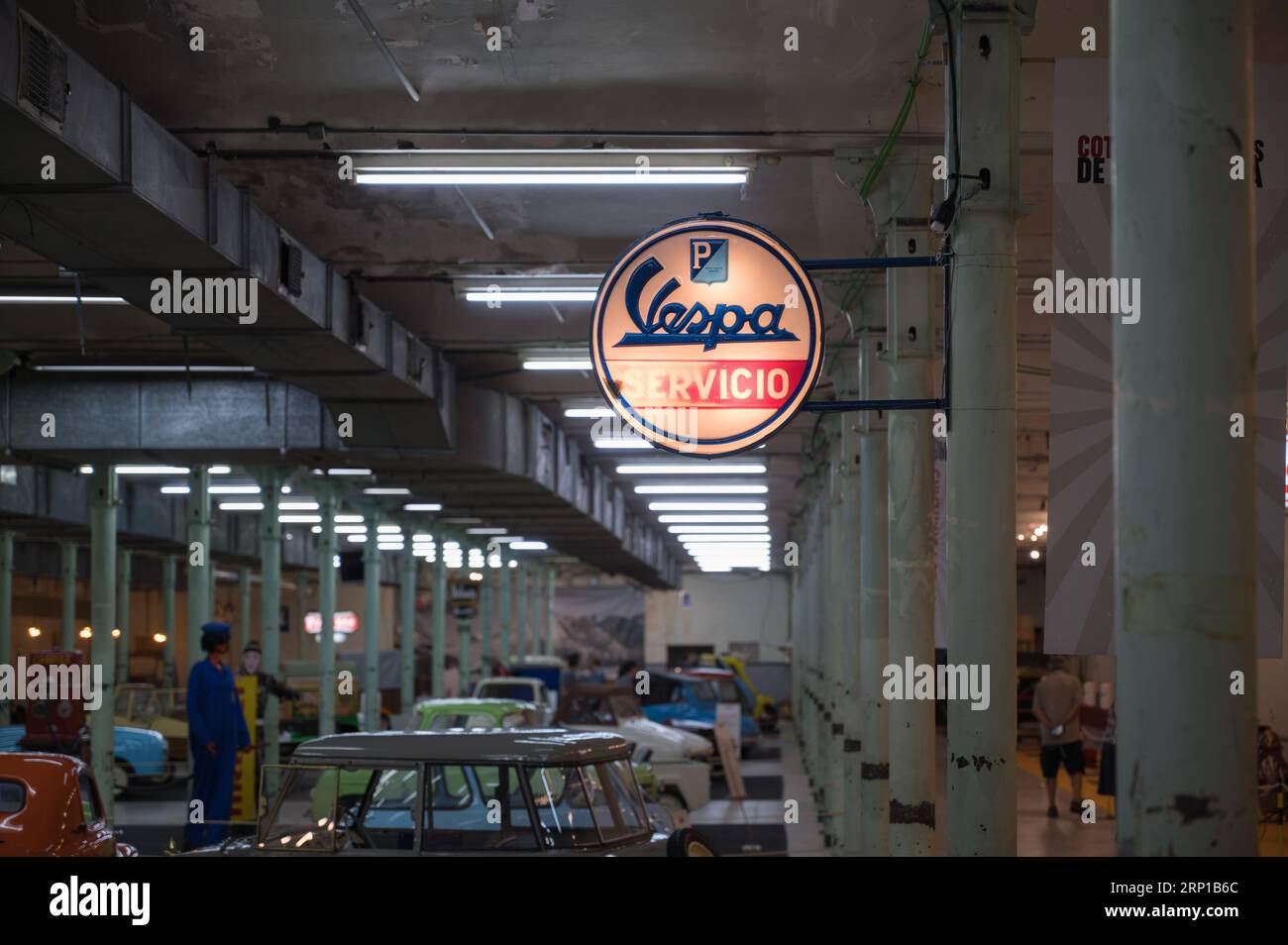 An old illuminated sign for the Vespa service station in an old ...