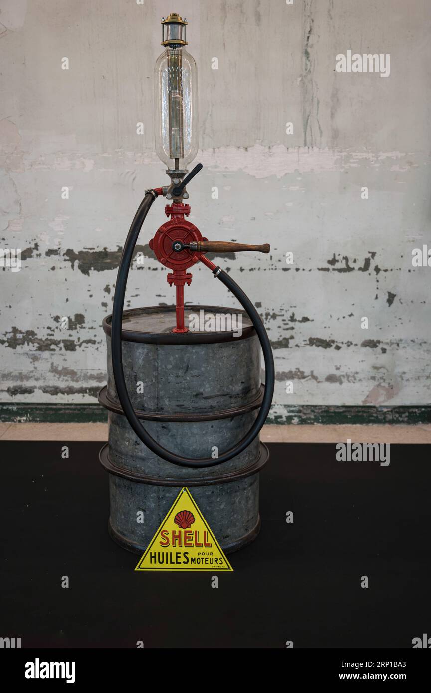 A closeup of an old gasoline barrel with a manual mechanical pump by ...