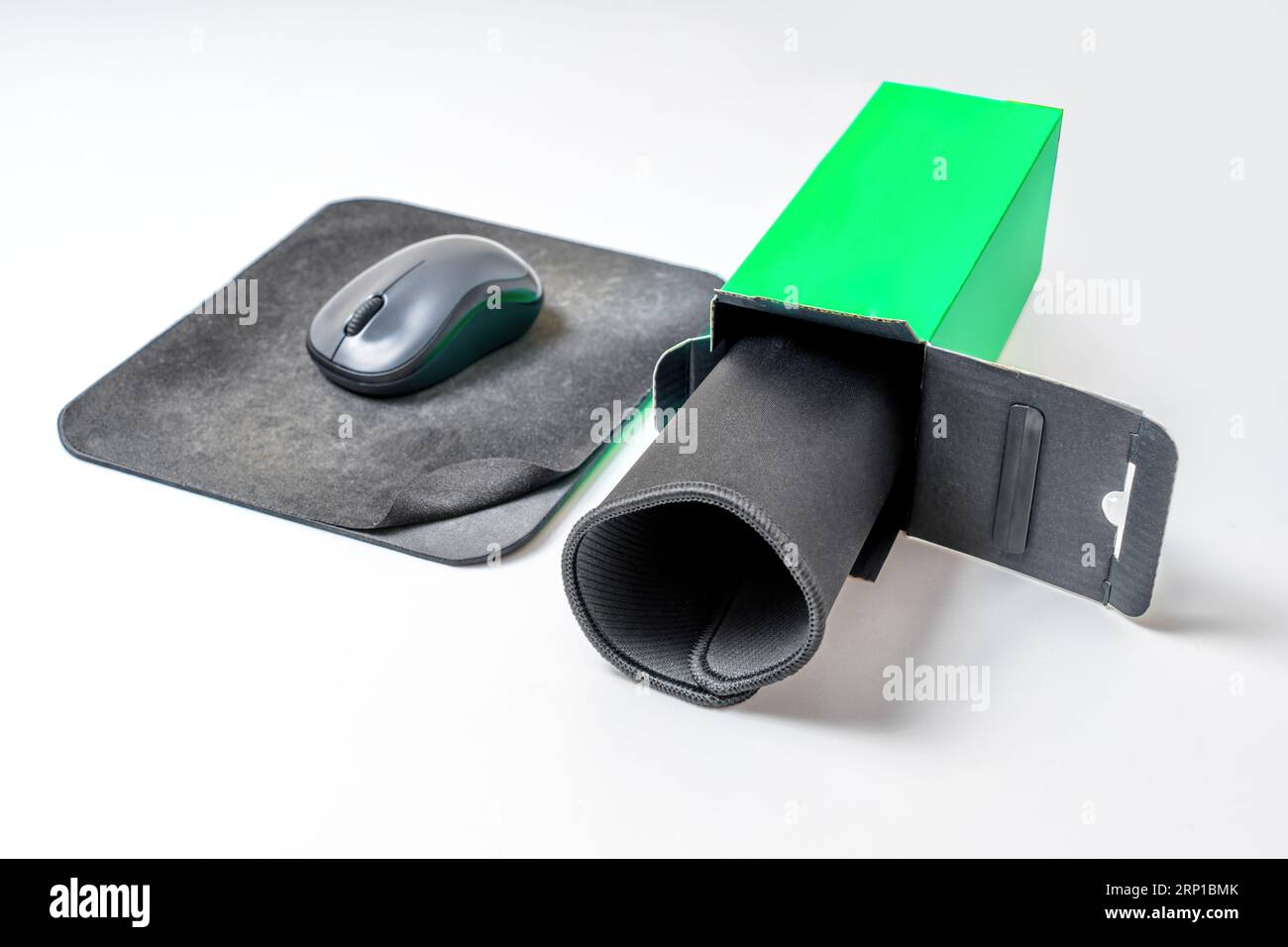 Open retail box with a brand new computer mouse pad placed by a well ...