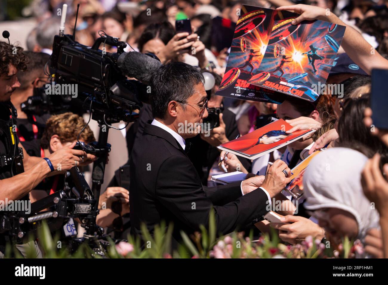 Tony Leung interacts with fans upon arrival for the Golden Lion for ...
