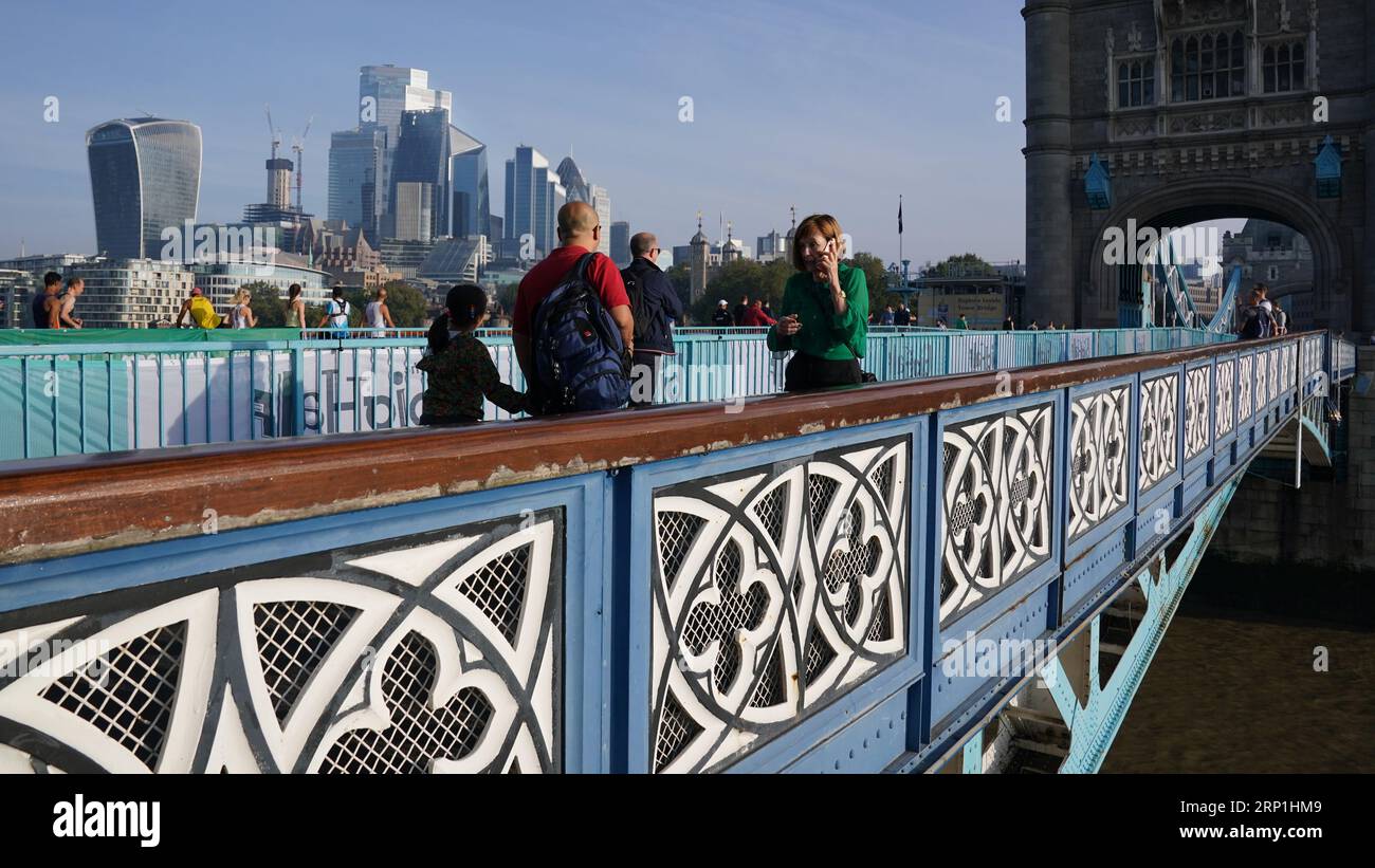 People walk across Tower Bridge in central London. Picture date: Sunday ...