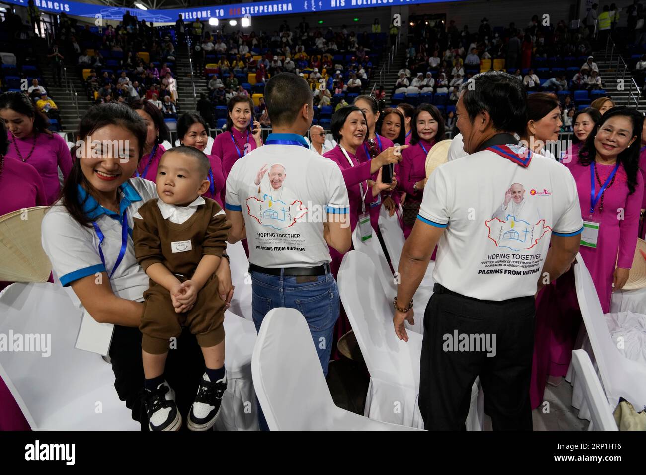 Faithful arrive at the Steppe Arena in the Mongolian capital ...