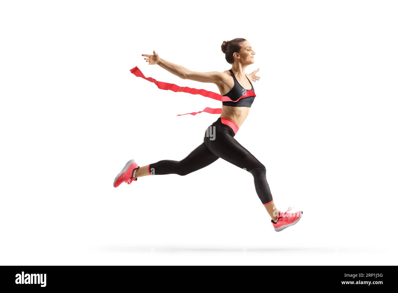 Full length profile shot of a female athlete finishing a race isolated ...