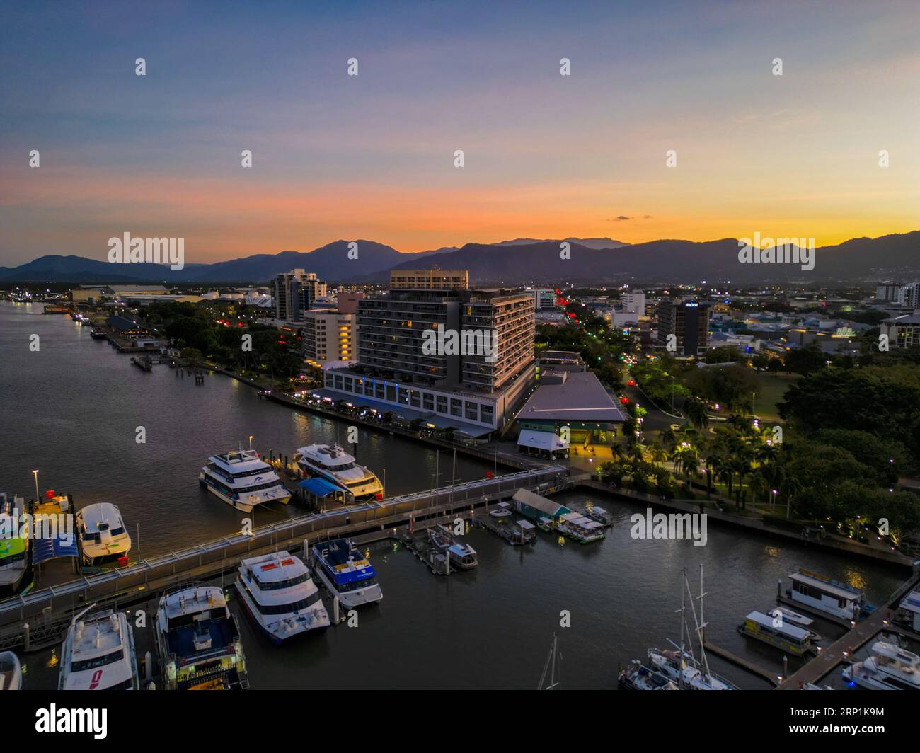 Night time sunset drone shot at Cairns Marina and Esplanade with orange ...
