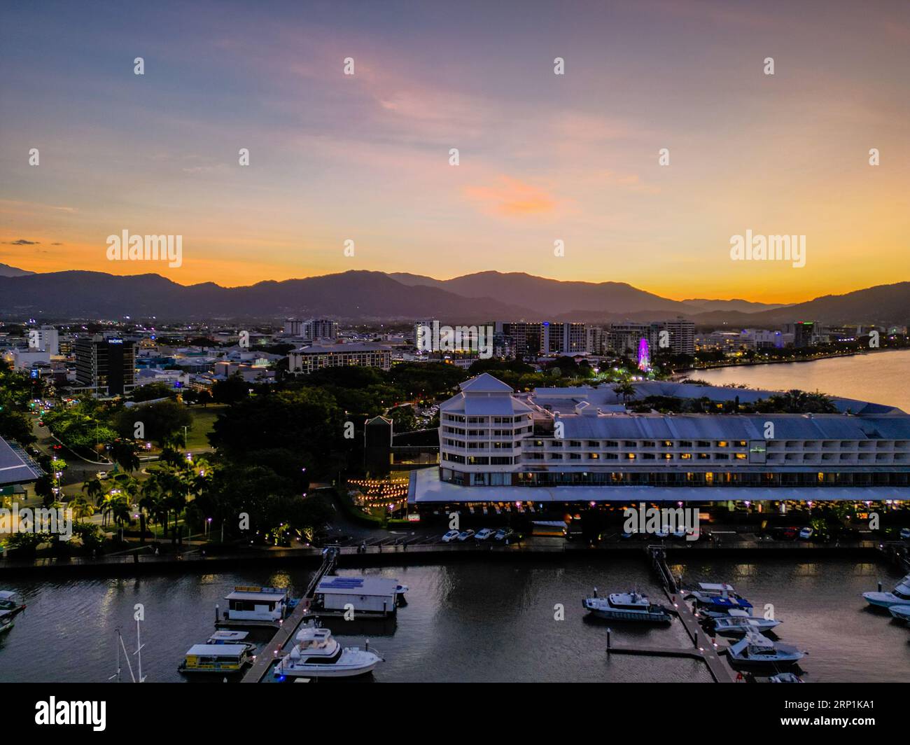 Night time sunset drone shot at Cairns Marina and Esplanade with orange ...