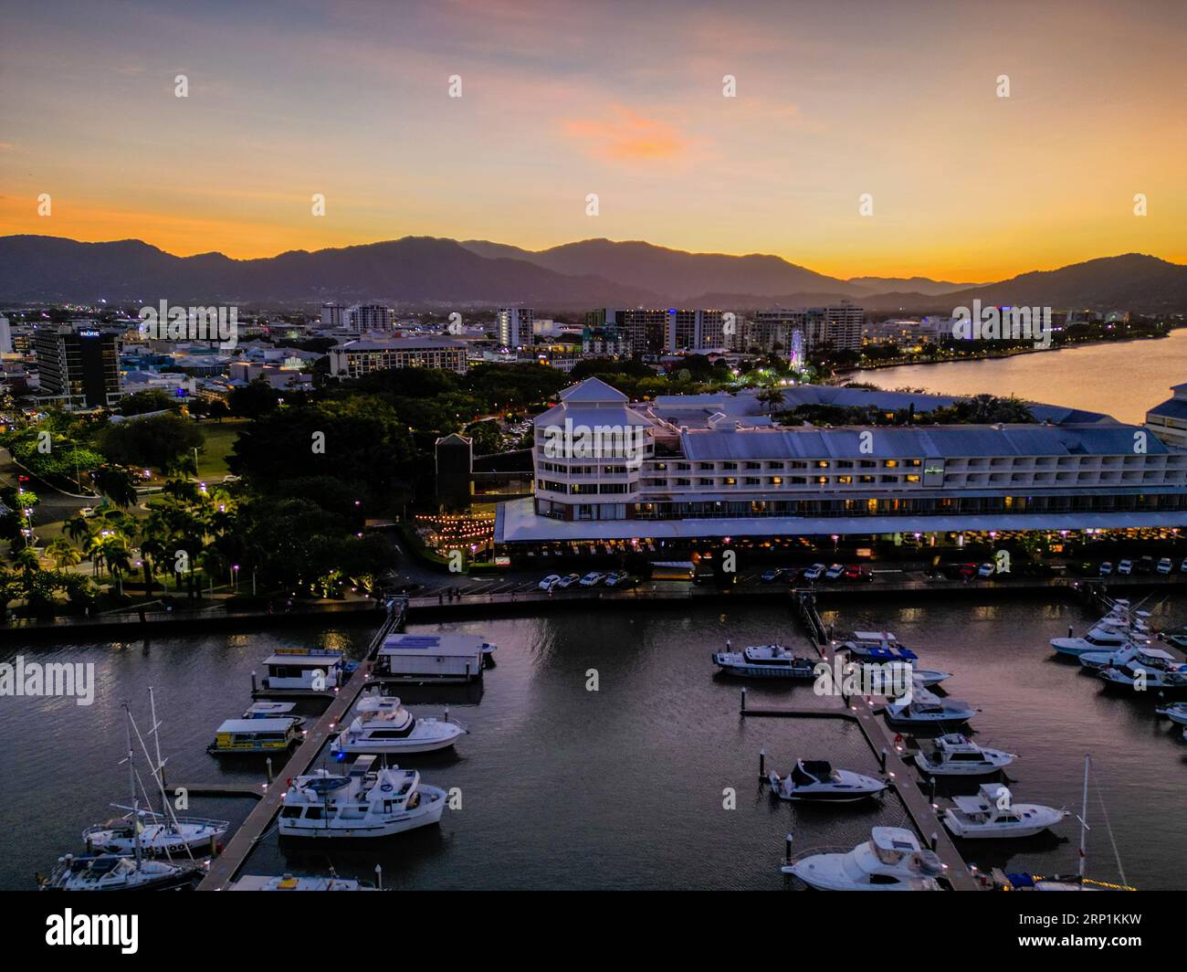 Night time sunset drone shot at Cairns Marina and Esplanade with orange ...