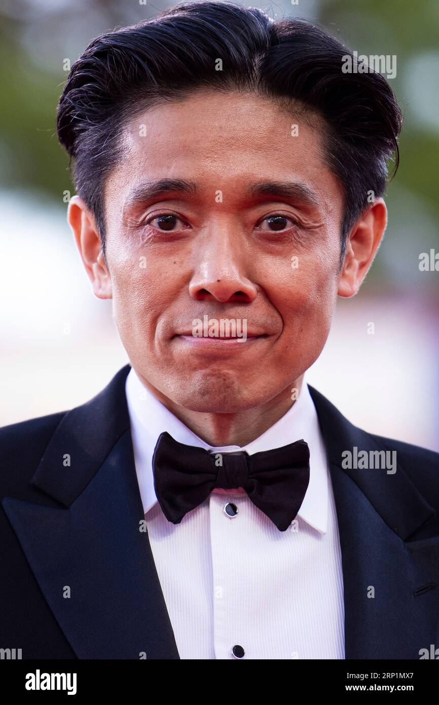 Kazu Hiro poses for photographers upon arrival for the premiere of the ...