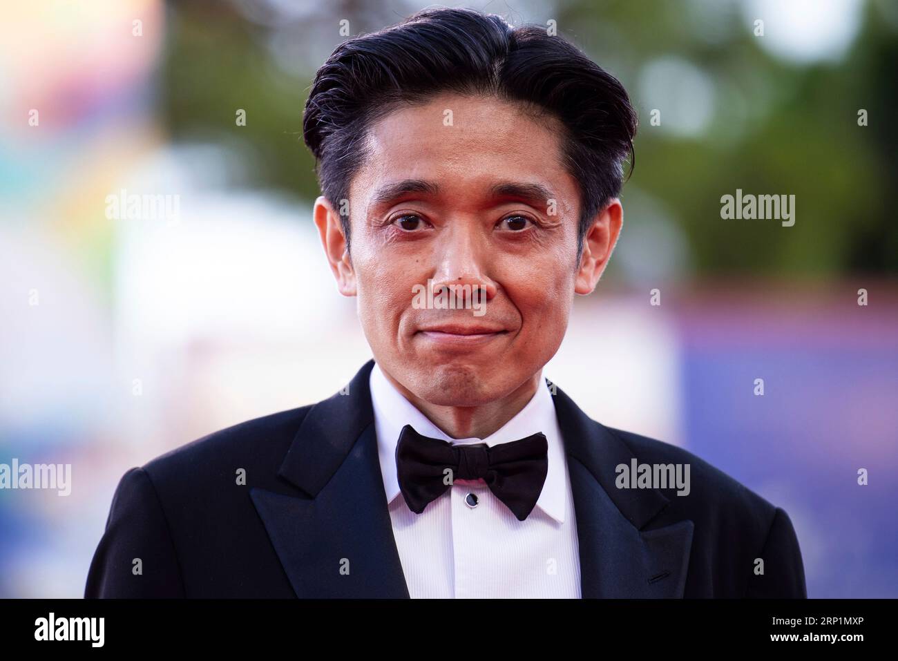Kazu Hiro poses for photographers upon arrival for the premiere of the ...