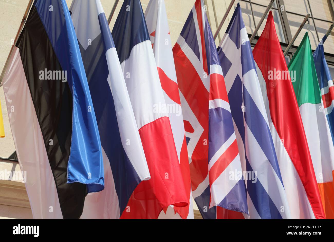 colorful flags of many world nations hanging outside government ...