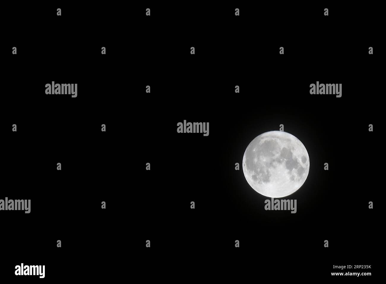 Full moon, white, in a horizontal frame, bottom right. The super blue ...