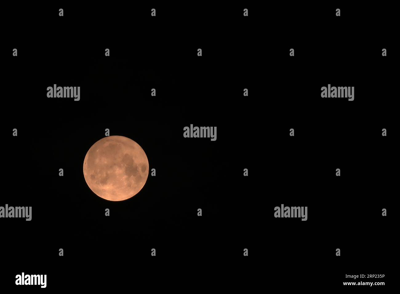 Red moon, bottom left in a horizontal frame. The super blue moon of ...