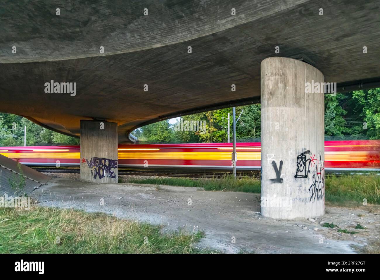 Regional train under a road bridge near Friedrichshafen, dynamic light ...