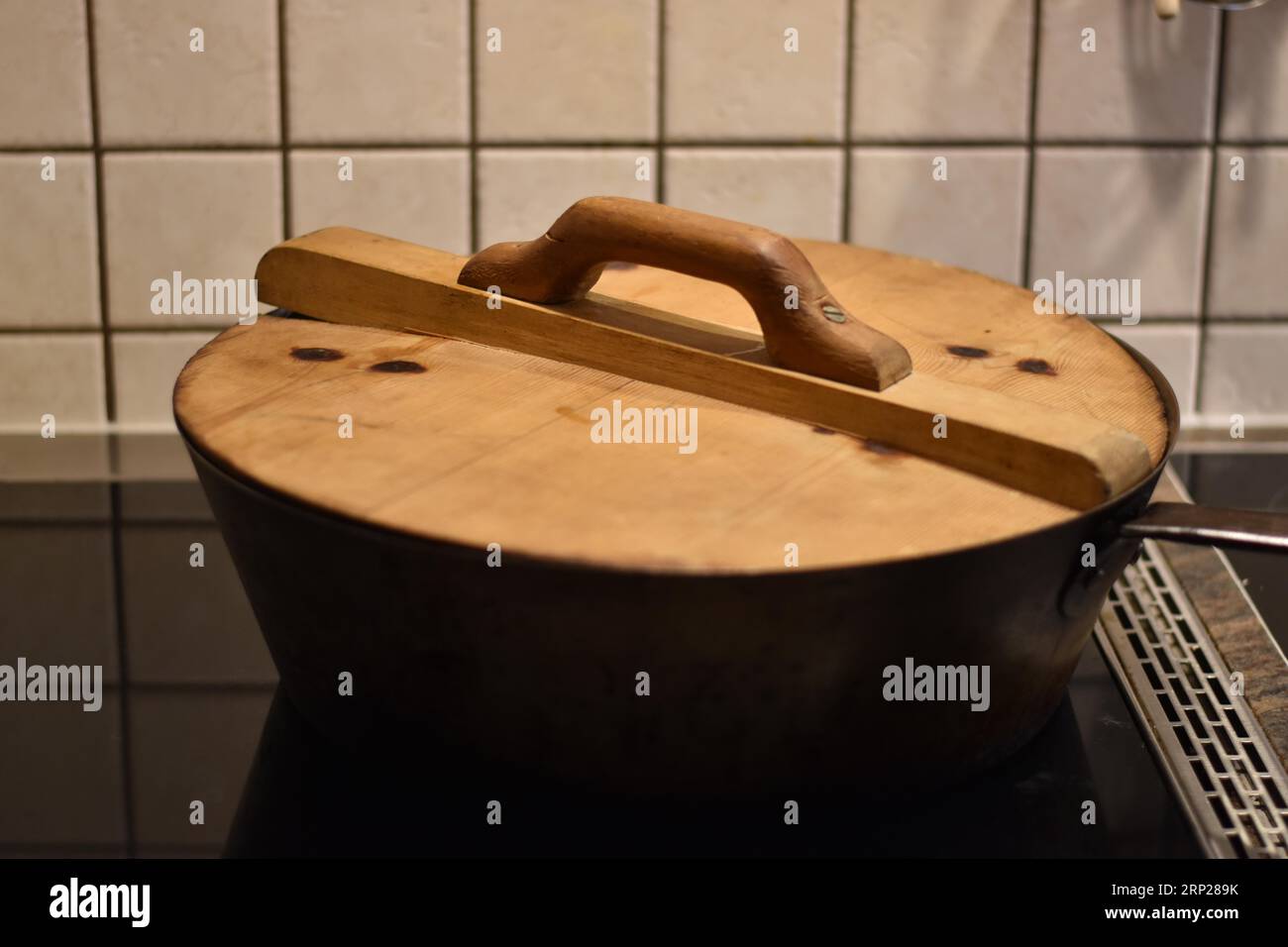 Preparation of steam noodles in rustic old steam noodle pan with wooden ...