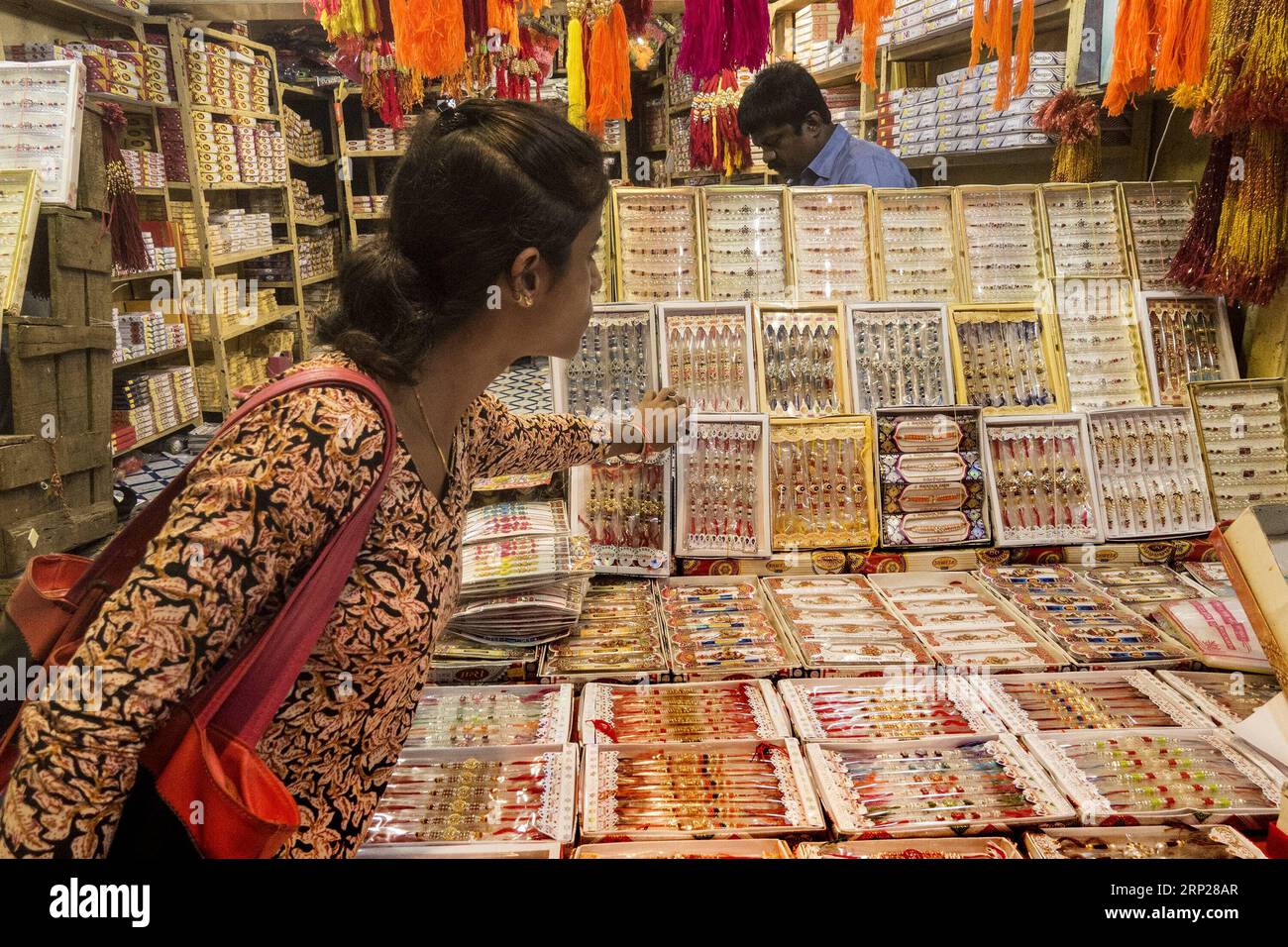(180824) -- KOLKATA, Aug. 24, 2018 -- An Indian woman buys Rakhis or ...