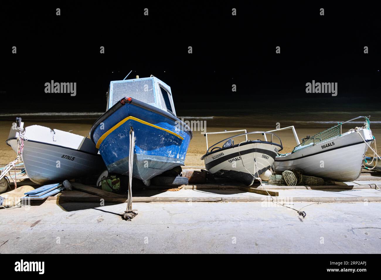 Several fishing boats lined up next to each other on the beach of Olhos ...