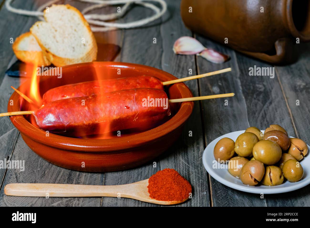 Chorizo grilled, chorizo al infierno, in a clay pot with bread, olives ...