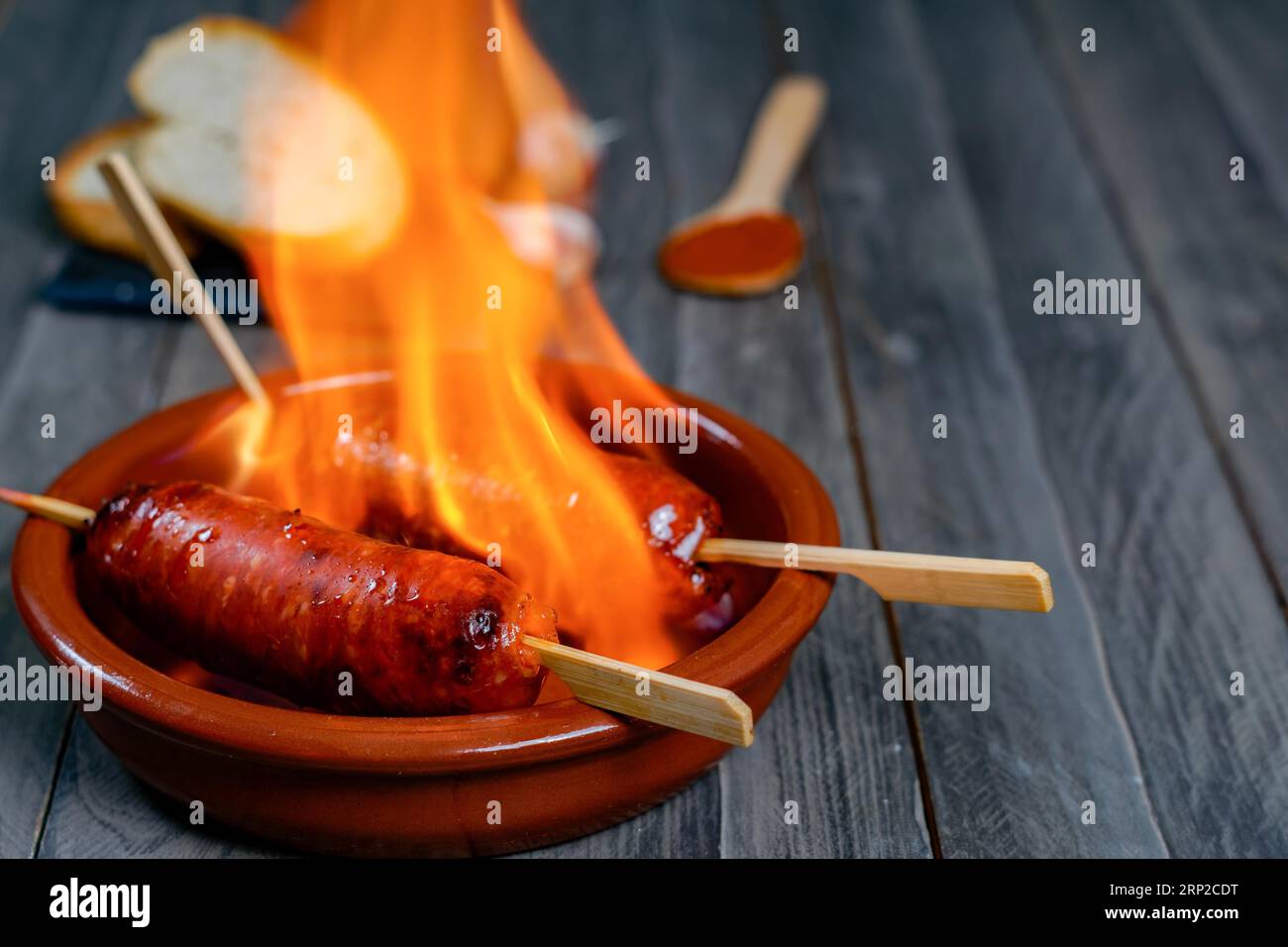 Chorizo grilled, chorizo al infierno, in a clay pot with bread, olives ...