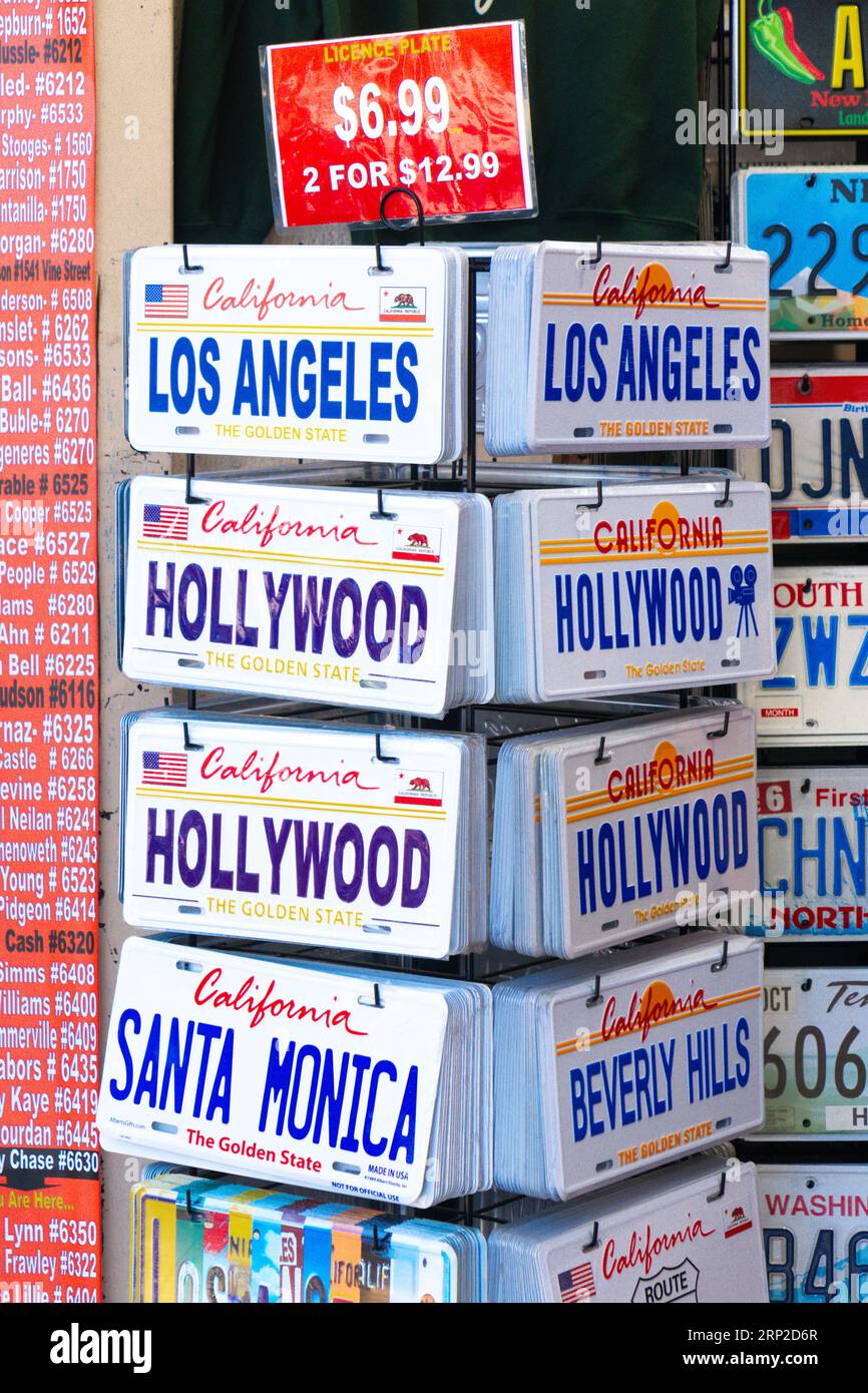 A display stand with various souvenir license plates featuring iconic ...