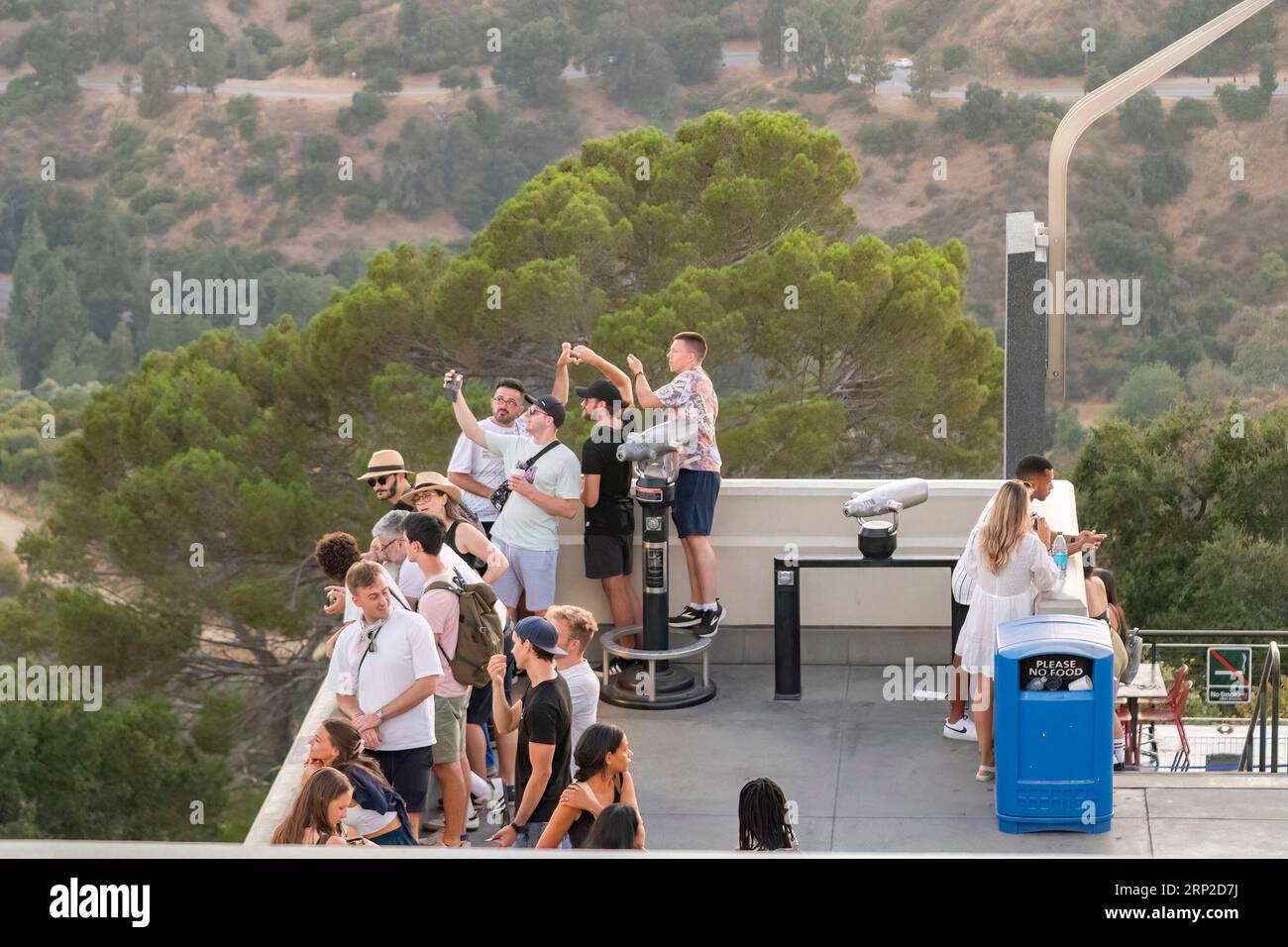 people photographing sunset from the balcony of the griffith park ...
