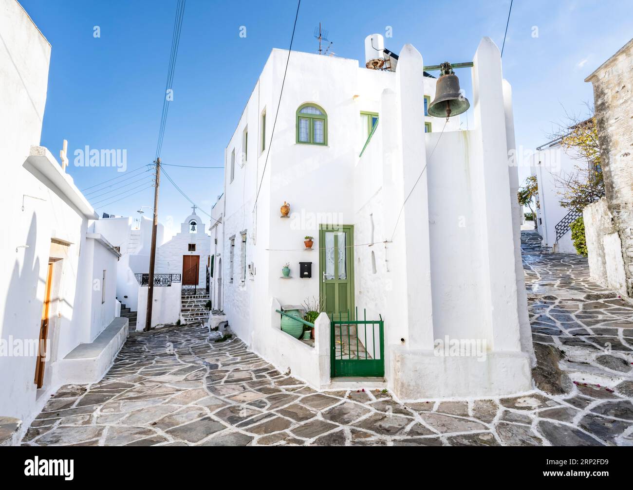 White Cycladic houses with green windows and doors, small Greek ...