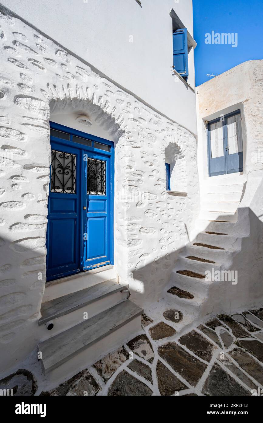White Cycladic houses with blue doors and windows, picturesque alleys ...