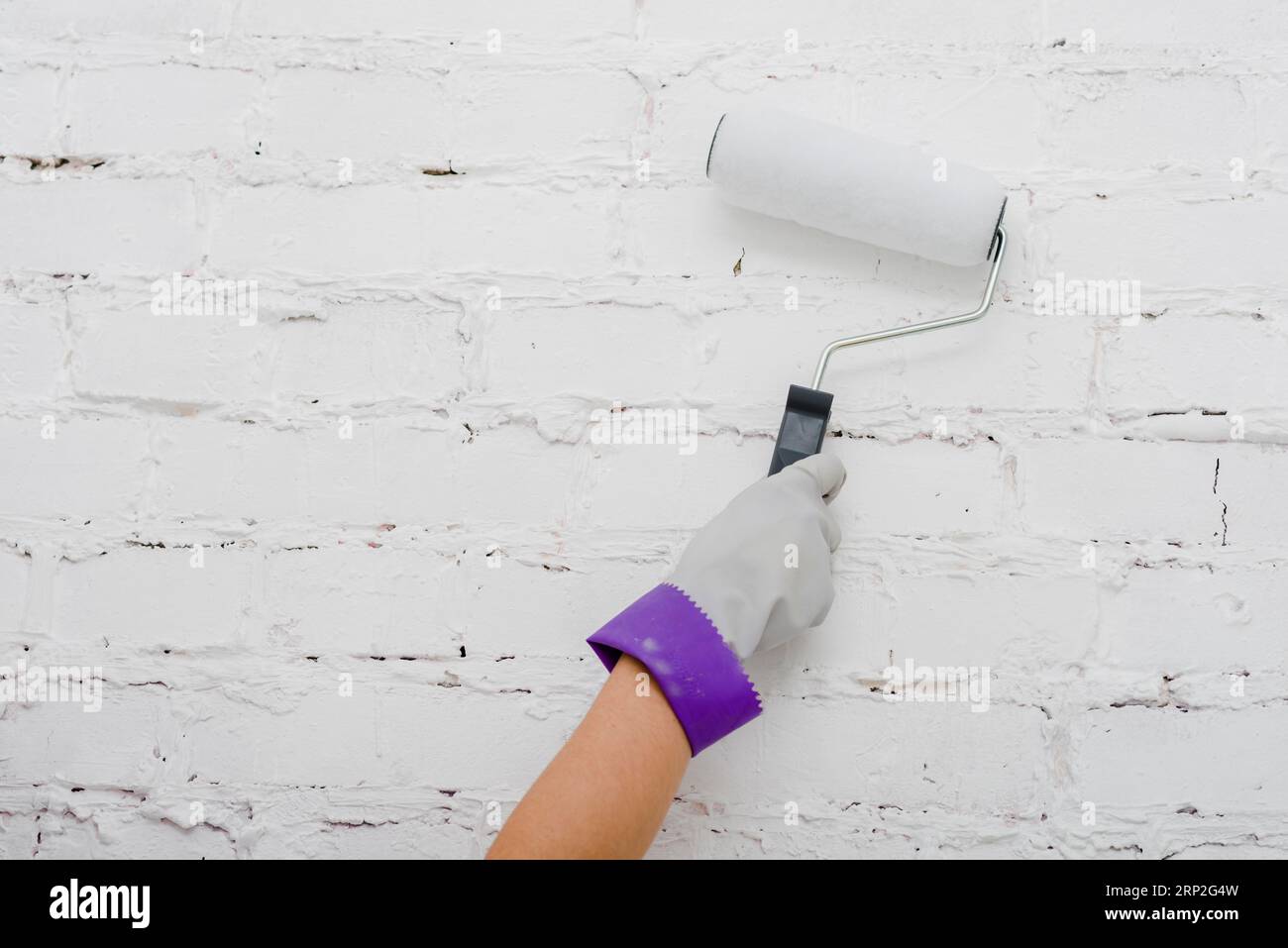 Crop hand painting wall Stock Photo - Alamy