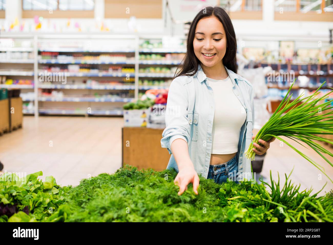 Happy asian woman picking greenery grocery store Stock Photo - Alamy