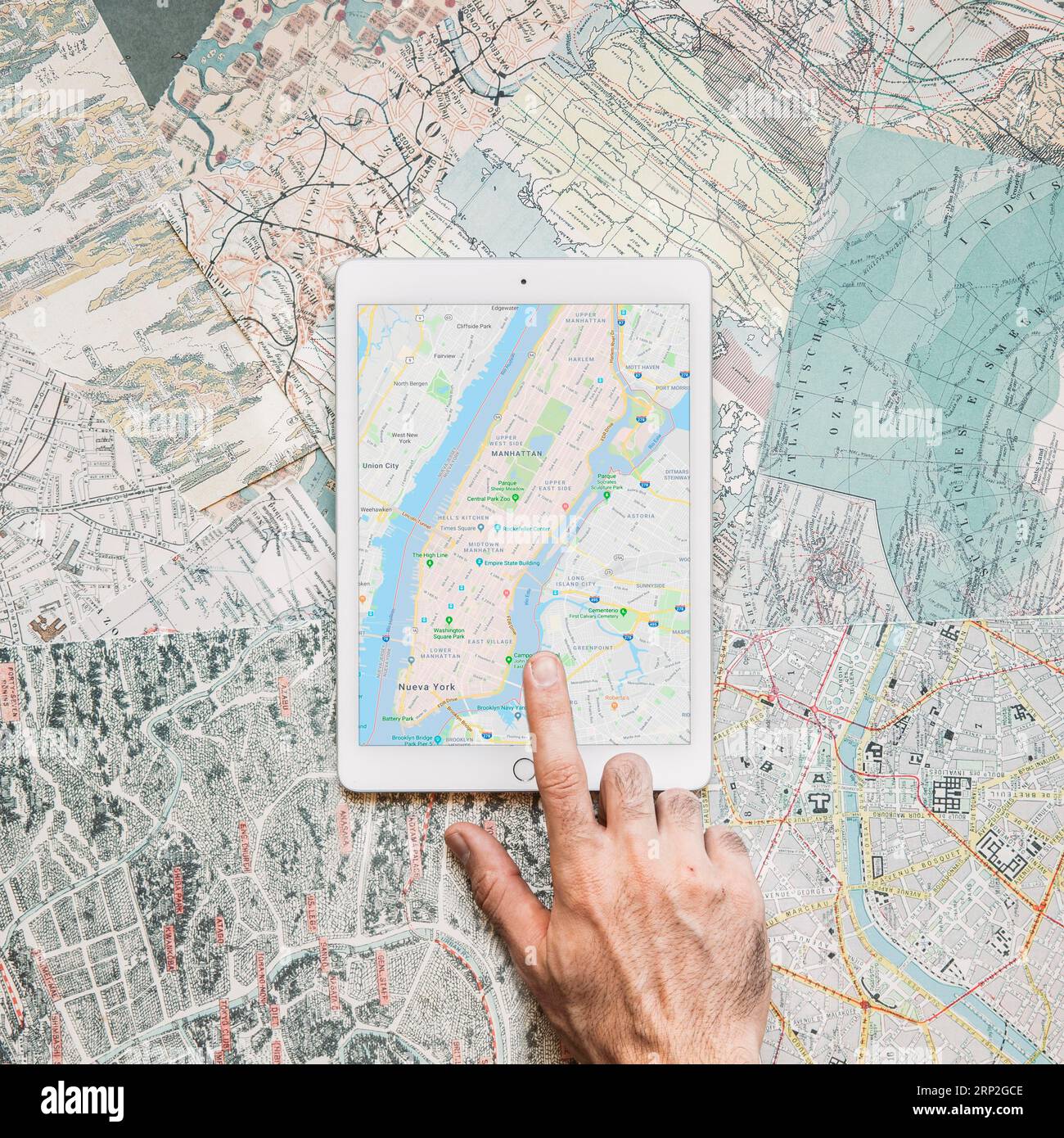 Hand tapping tablet with map Stock Photo - Alamy