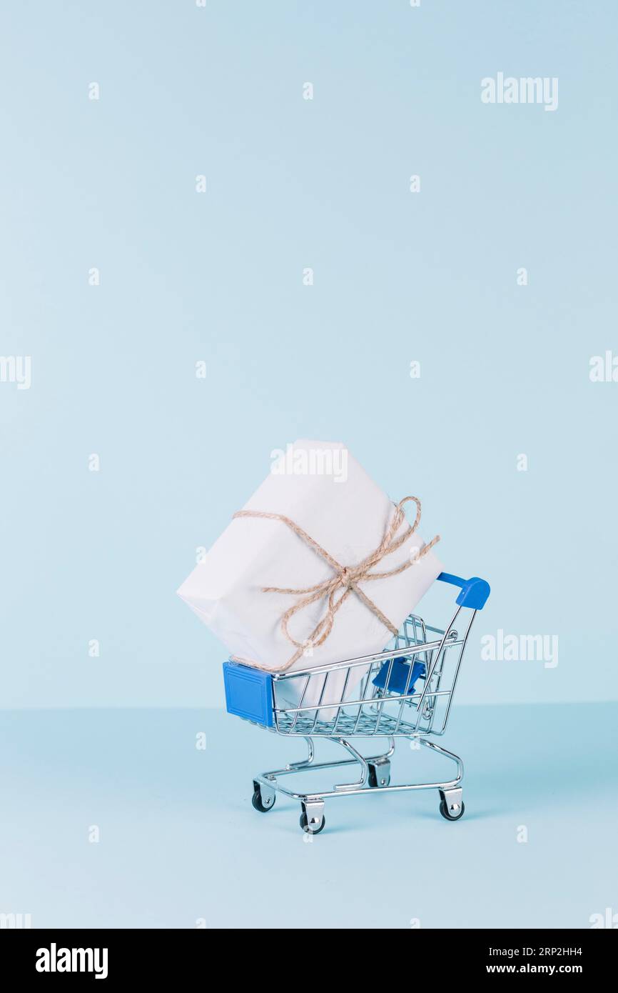 White package shopping cart blue background Stock Photo - Alamy