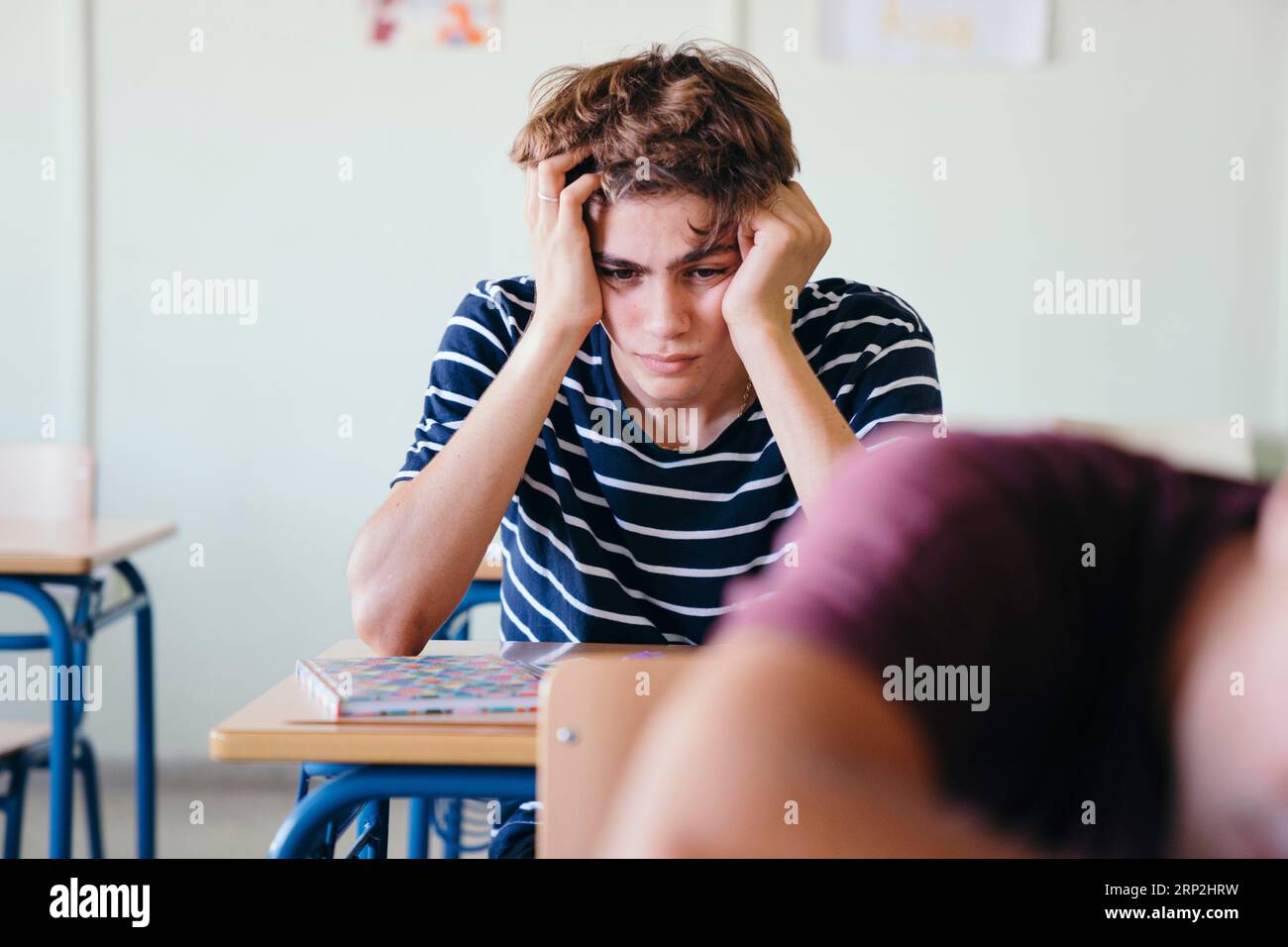 Worried student classroom Stock Photo - Alamy