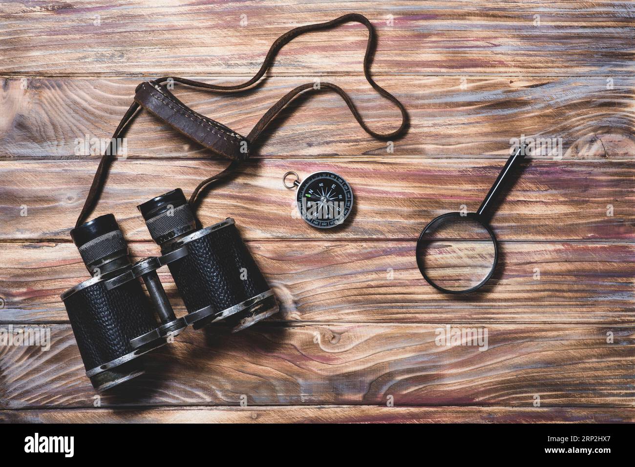 Wooden background with binocular compass magnifying glass Stock Photo - Alamy