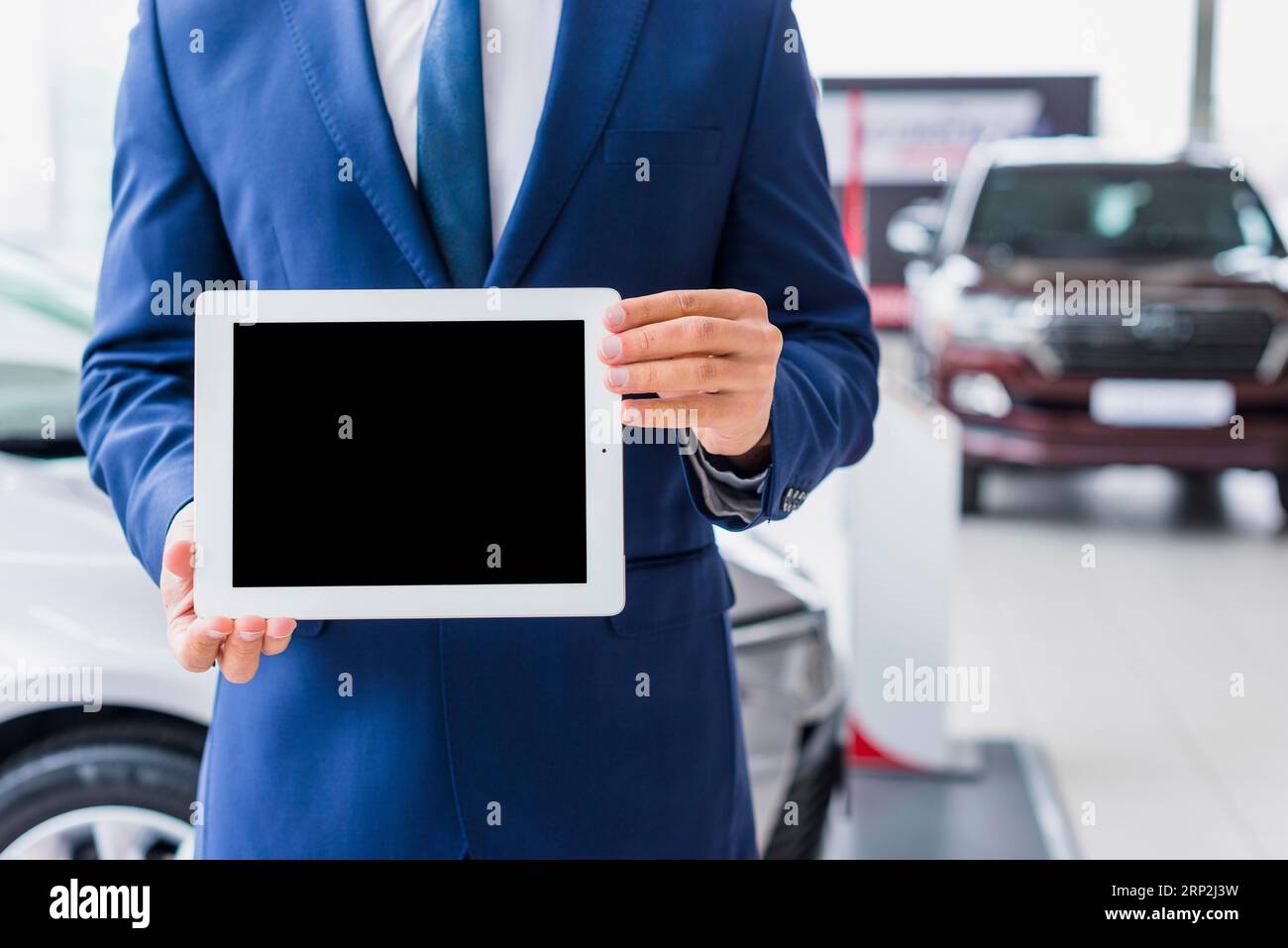 Car salesman with tablet Stock Photo - Alamy