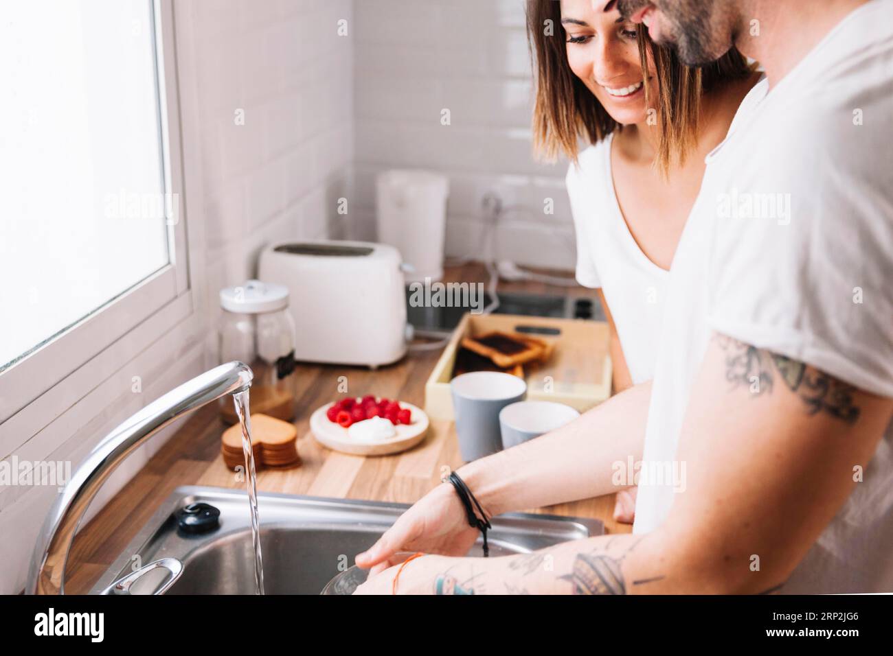 Couple washing dishes together Stock Photo - Alamy