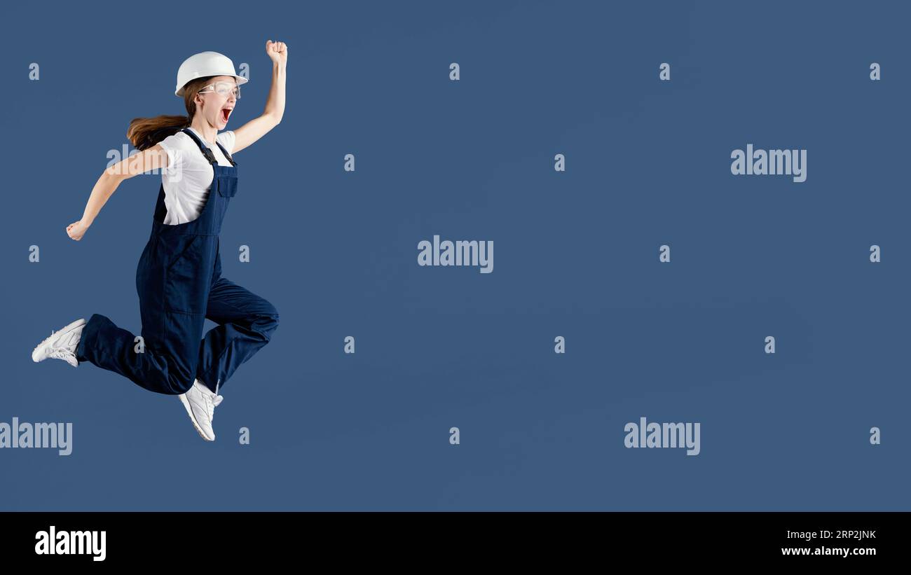 Engineer woman jumping Stock Photo - Alamy