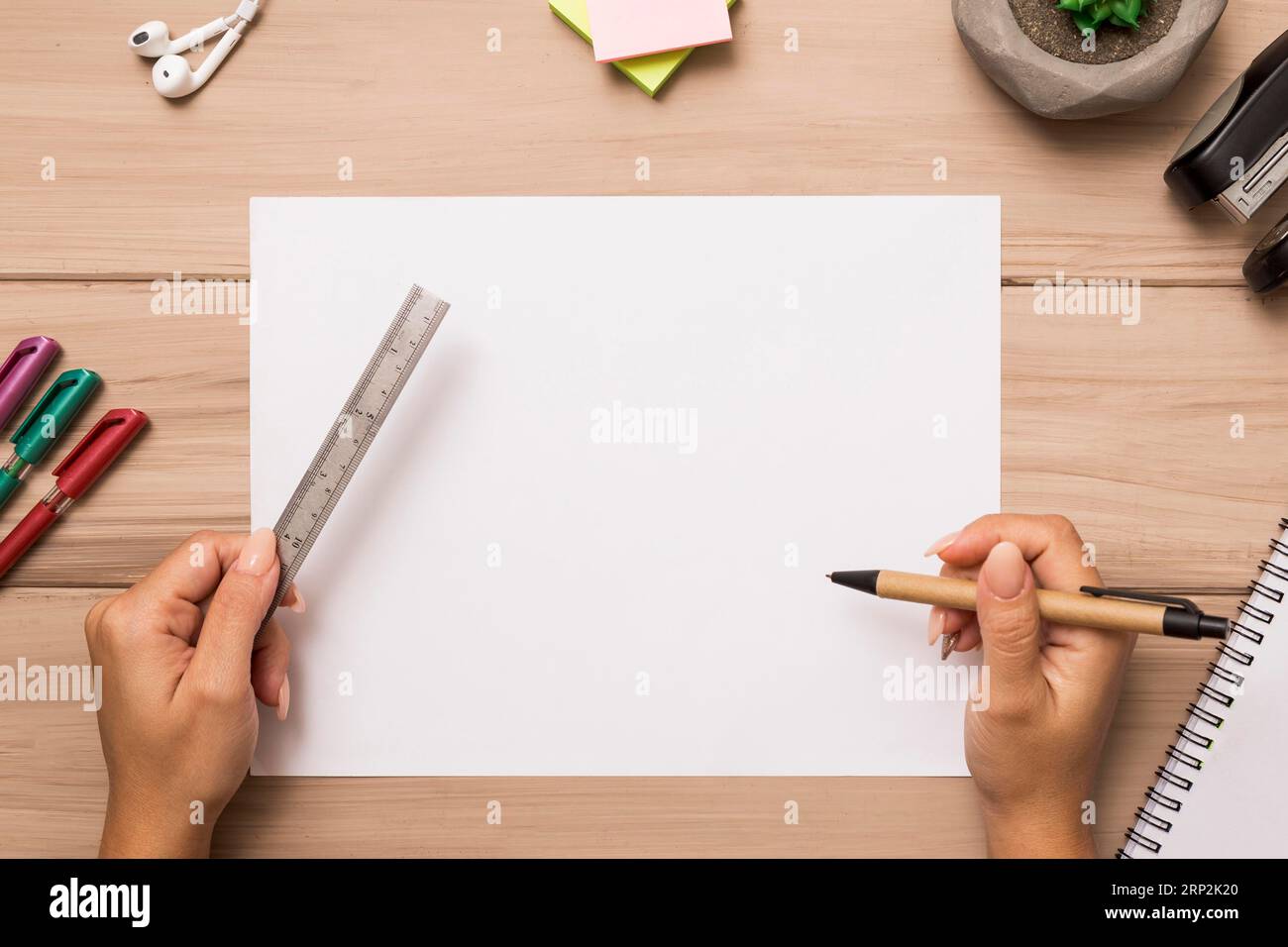 From hands holding ruler pen blank paper sheet Stock Photo - Alamy