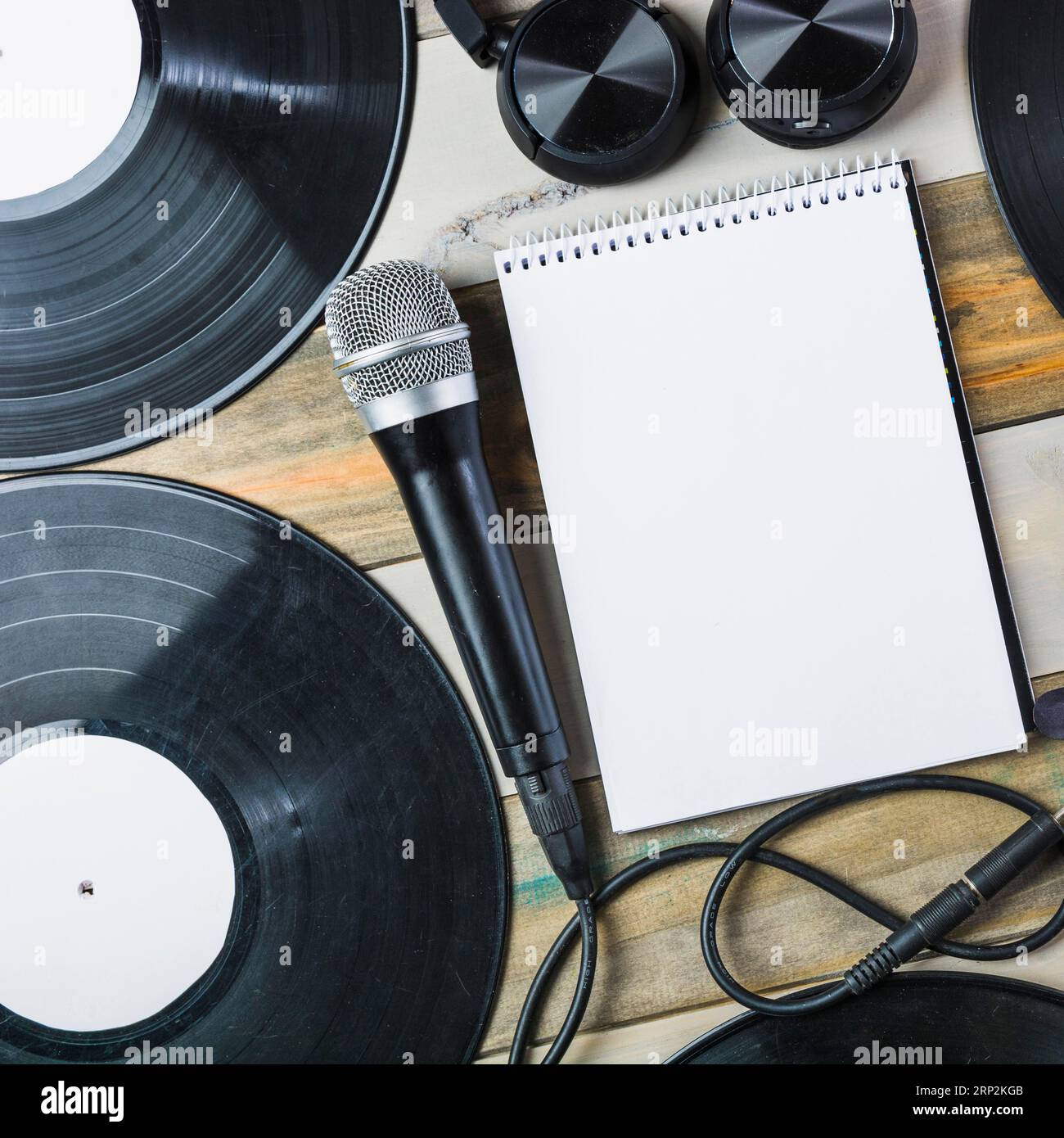 Headphone microphone vinyl record blank spiral notepad wooden table ...