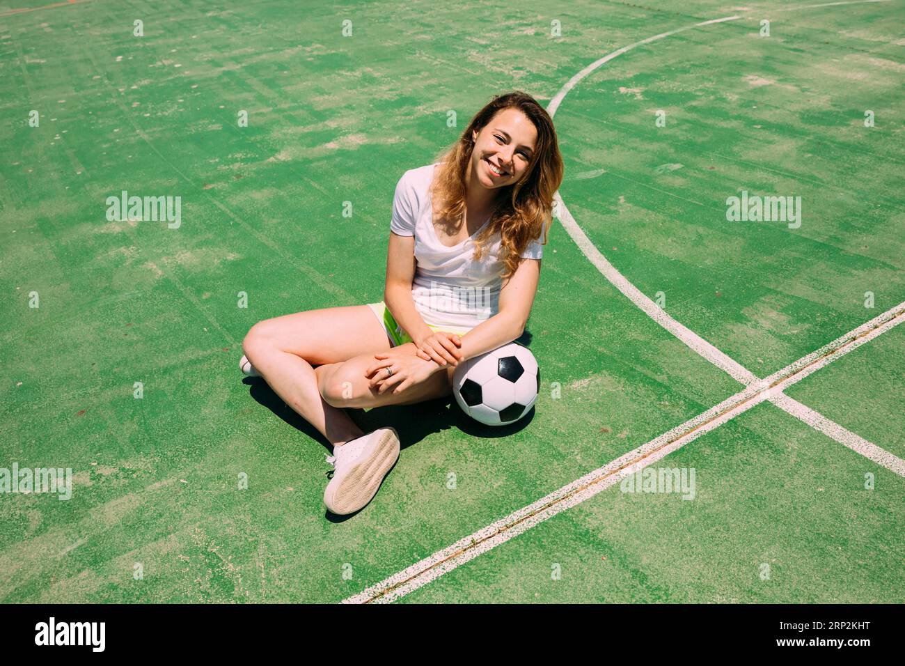 Happy teenager with ball football pitch Stock Photo - Alamy