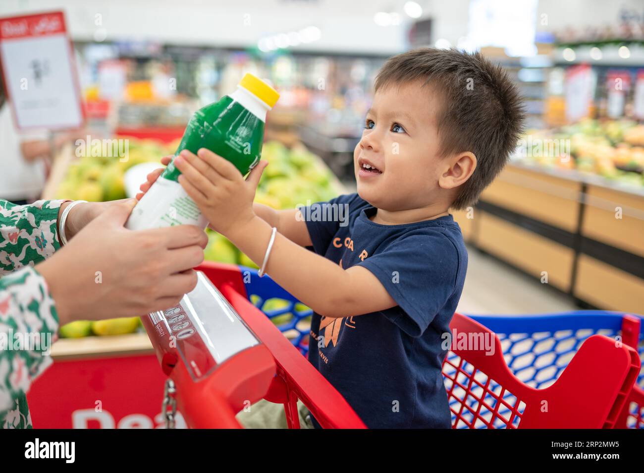 Child trolley supermarket boy pushing trolley hi-res stock photography ...