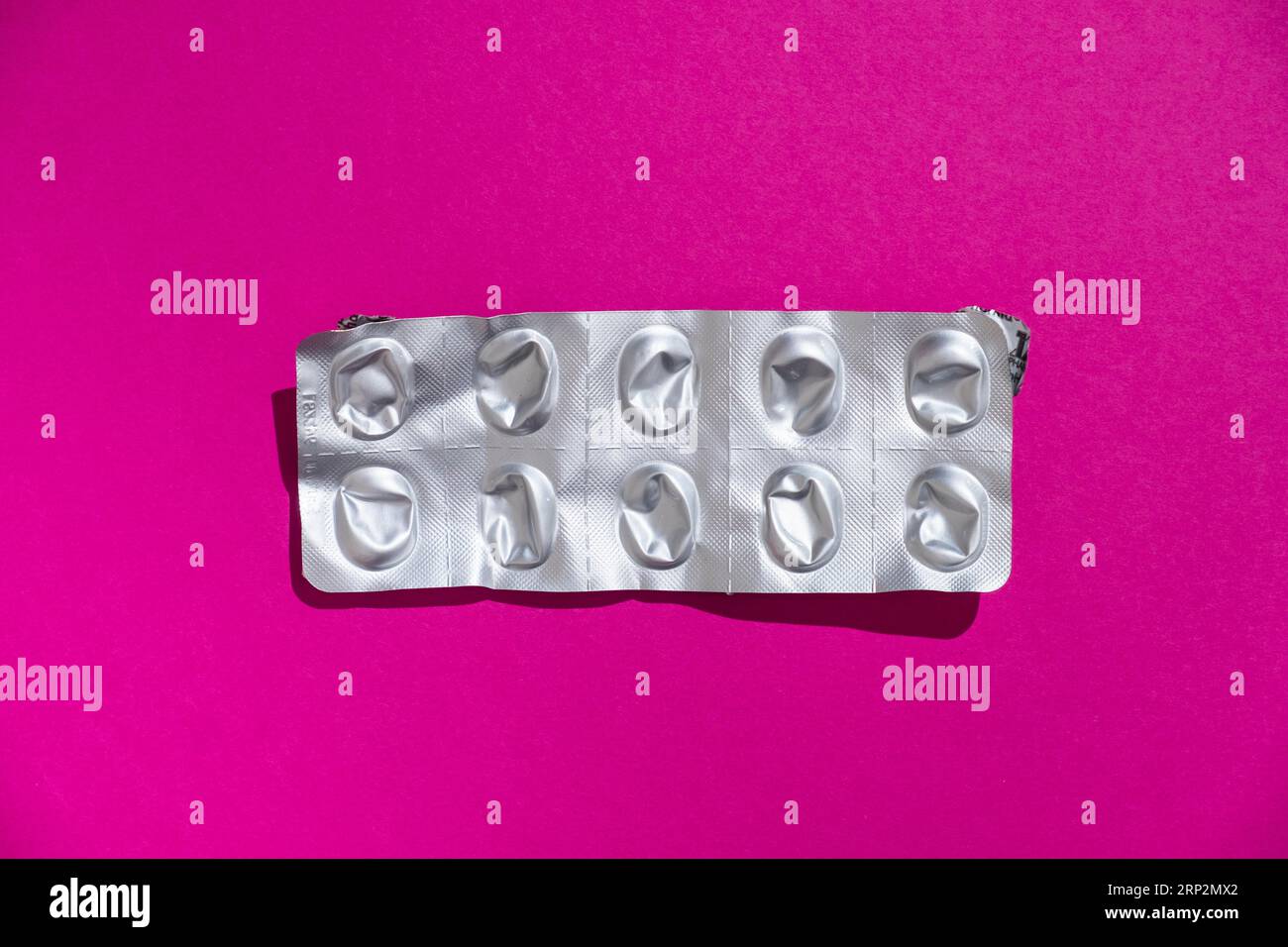 Empty tablet blister pack against a monochrome background, top view ...