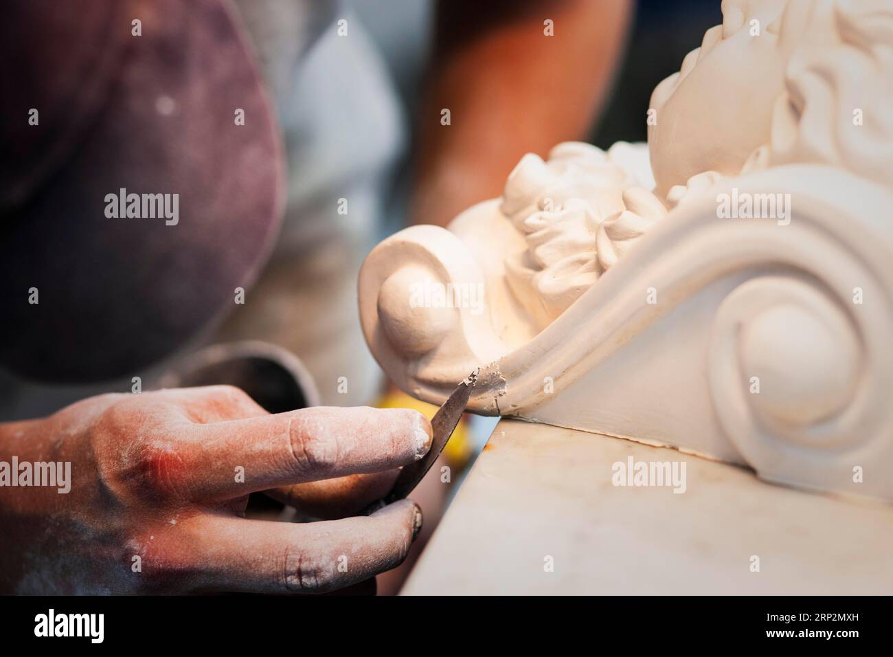 A plasterer restores a stucco figure Stock Photo - Alamy